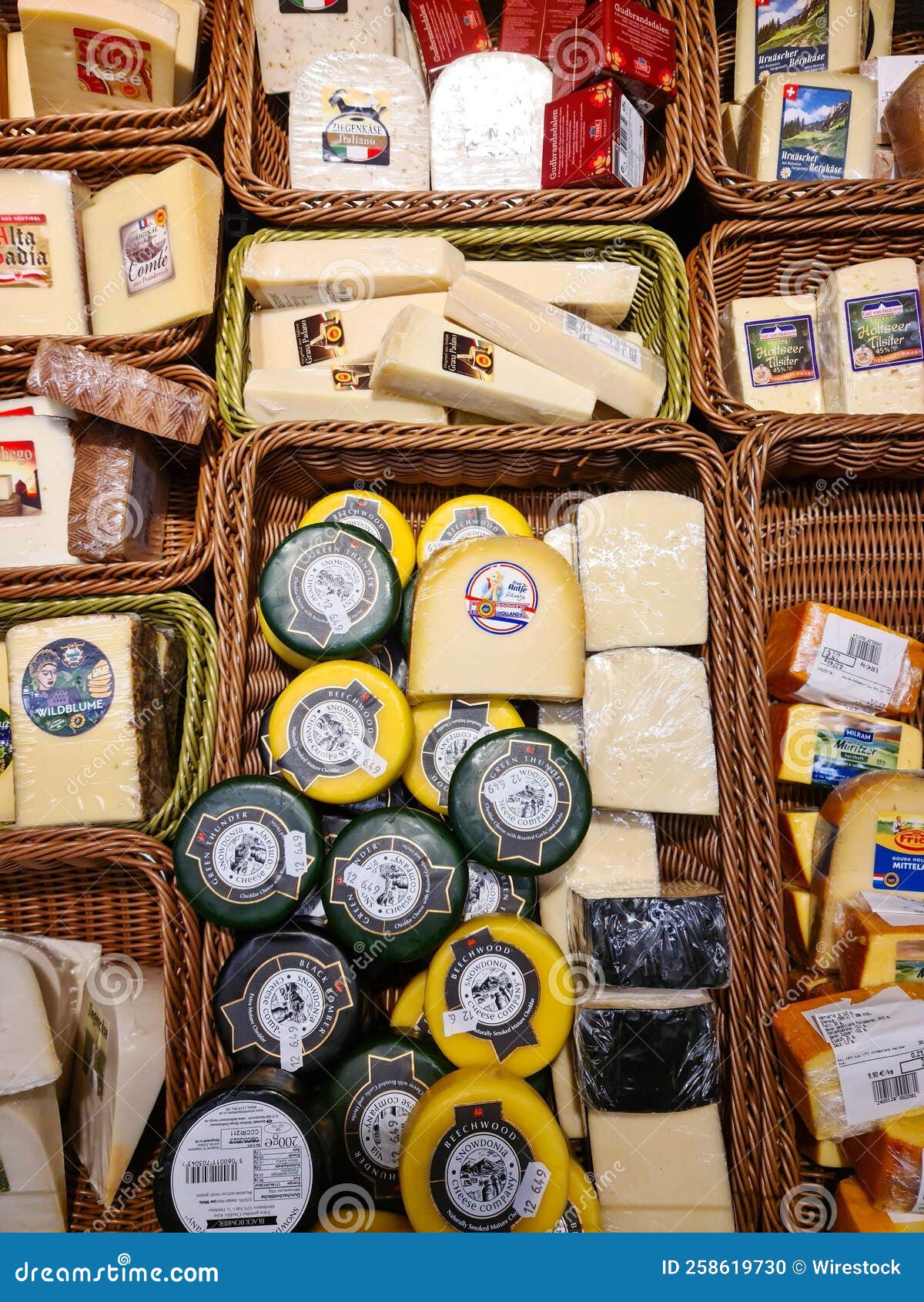 Packaged Varieties of Cheese in Display with Baskets in a Supermarket ...