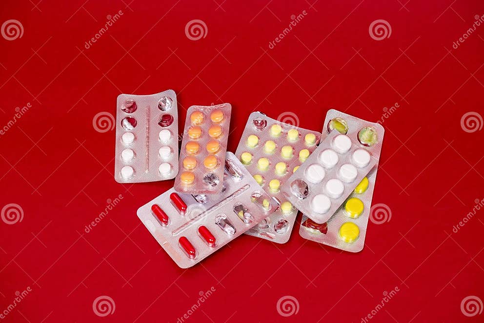 Packages of Different Tablets and Capsules on a Red Background Stock ...