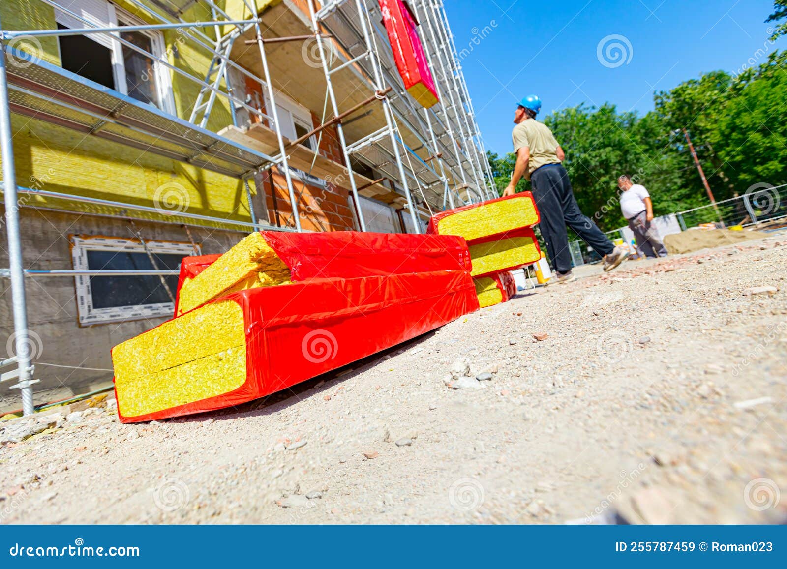 Packages with Stone Wool Arranged in a Pile, the Workman is Hanging the ...
