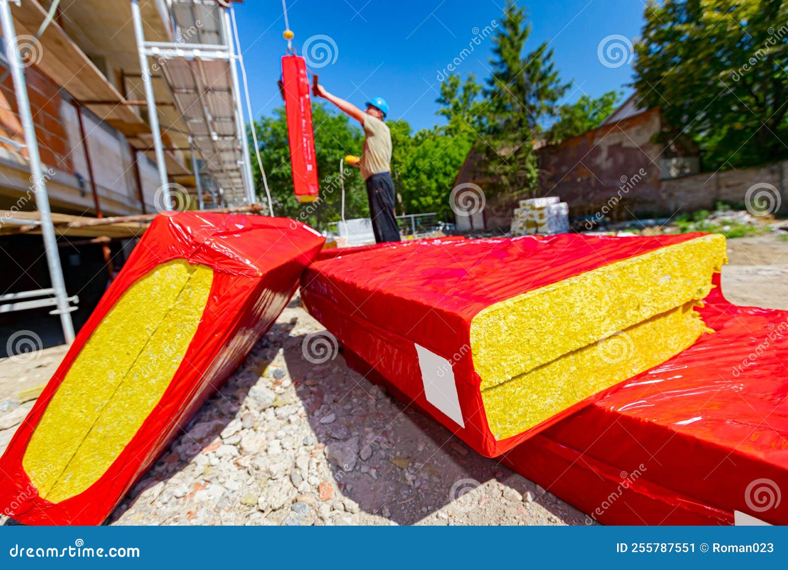 Packages with Stone Wool Arranged in a Pile, the Workman is Hanging the ...