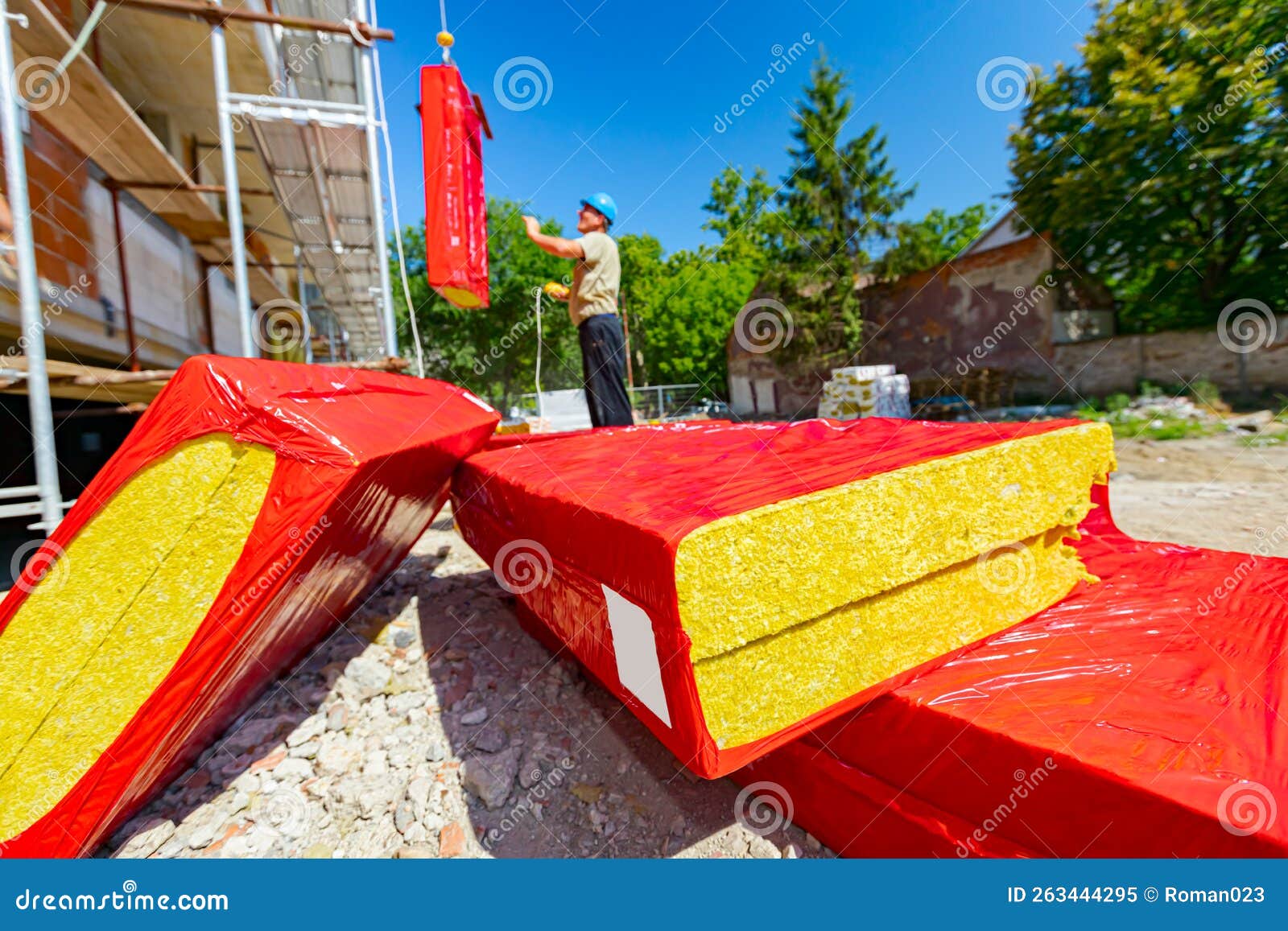 Packages with Stone Wool Arranged in a Pile, the Workman is Hanging the ...