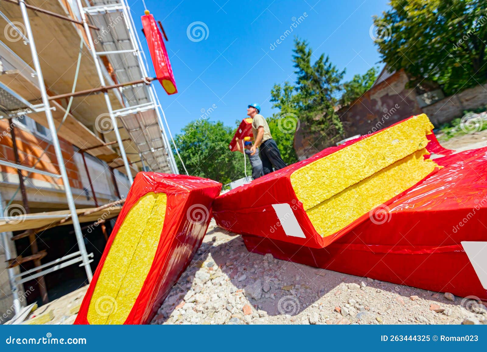 Packages with Stone Wool Arranged in a Pile, the Workman is Hanging the ...