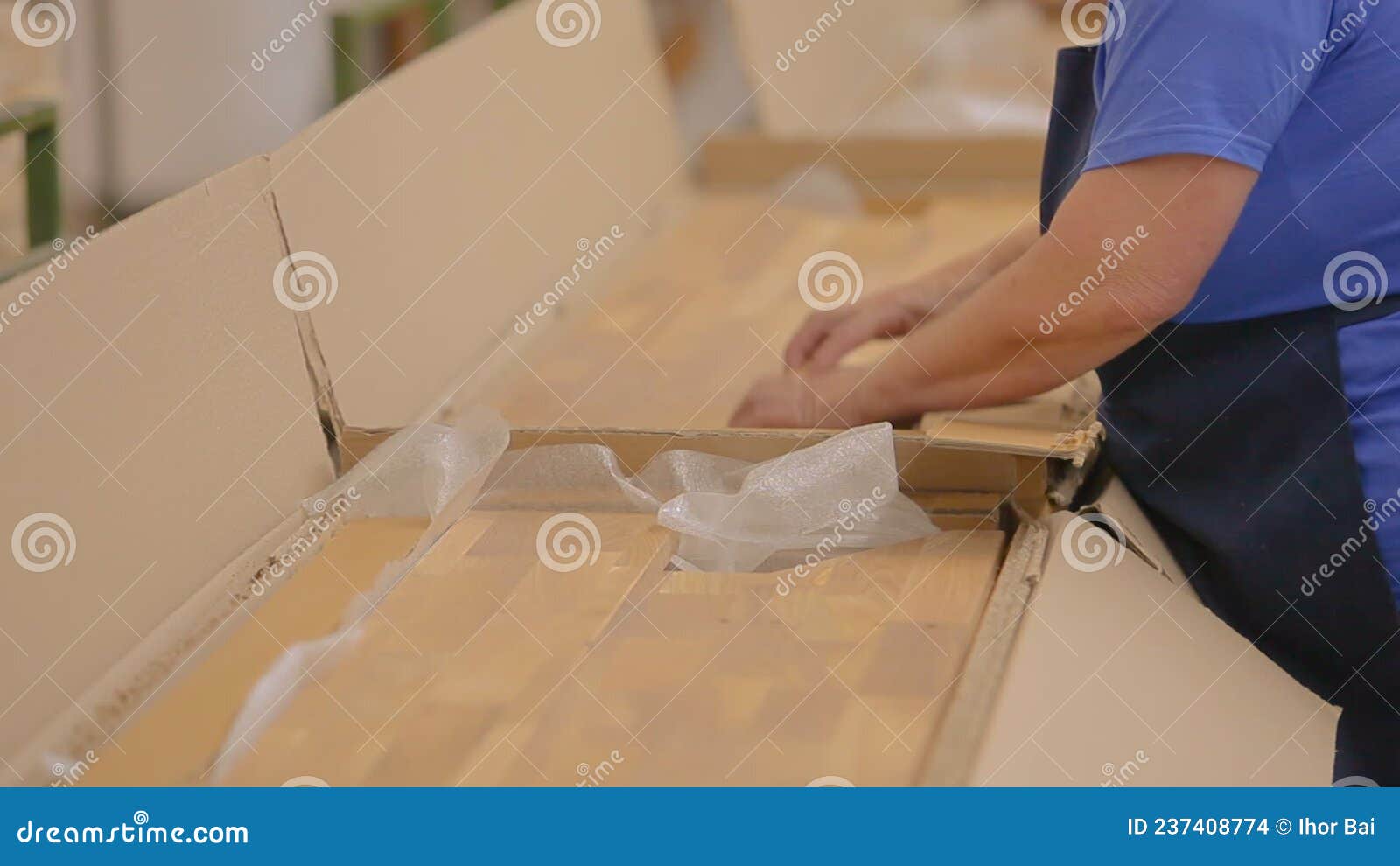 Packaging of Finished Goods in a Box. Workers Pack Finished Products ...