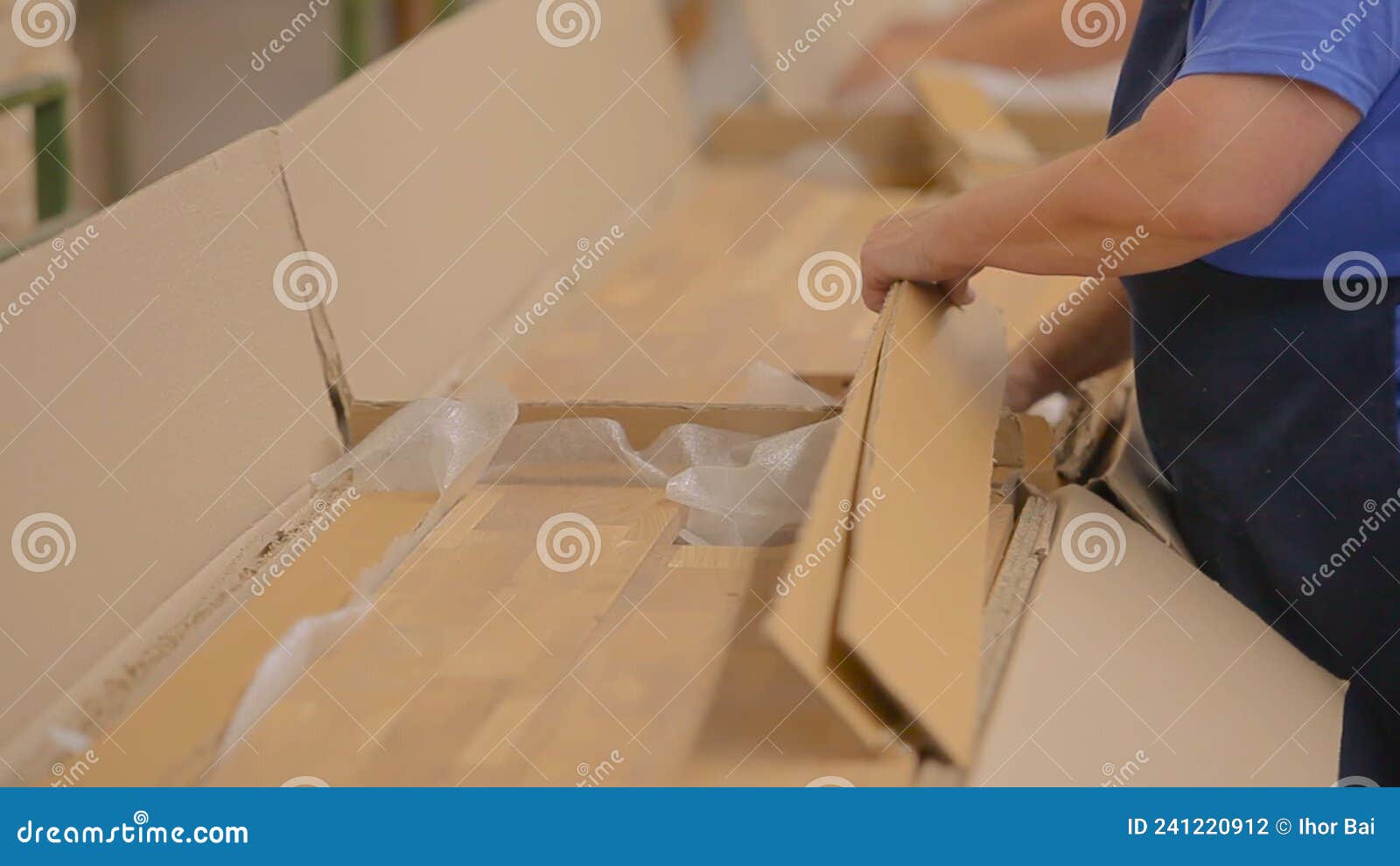 Packaging of Finished Goods in a Box. Workers Pack Finished Products ...