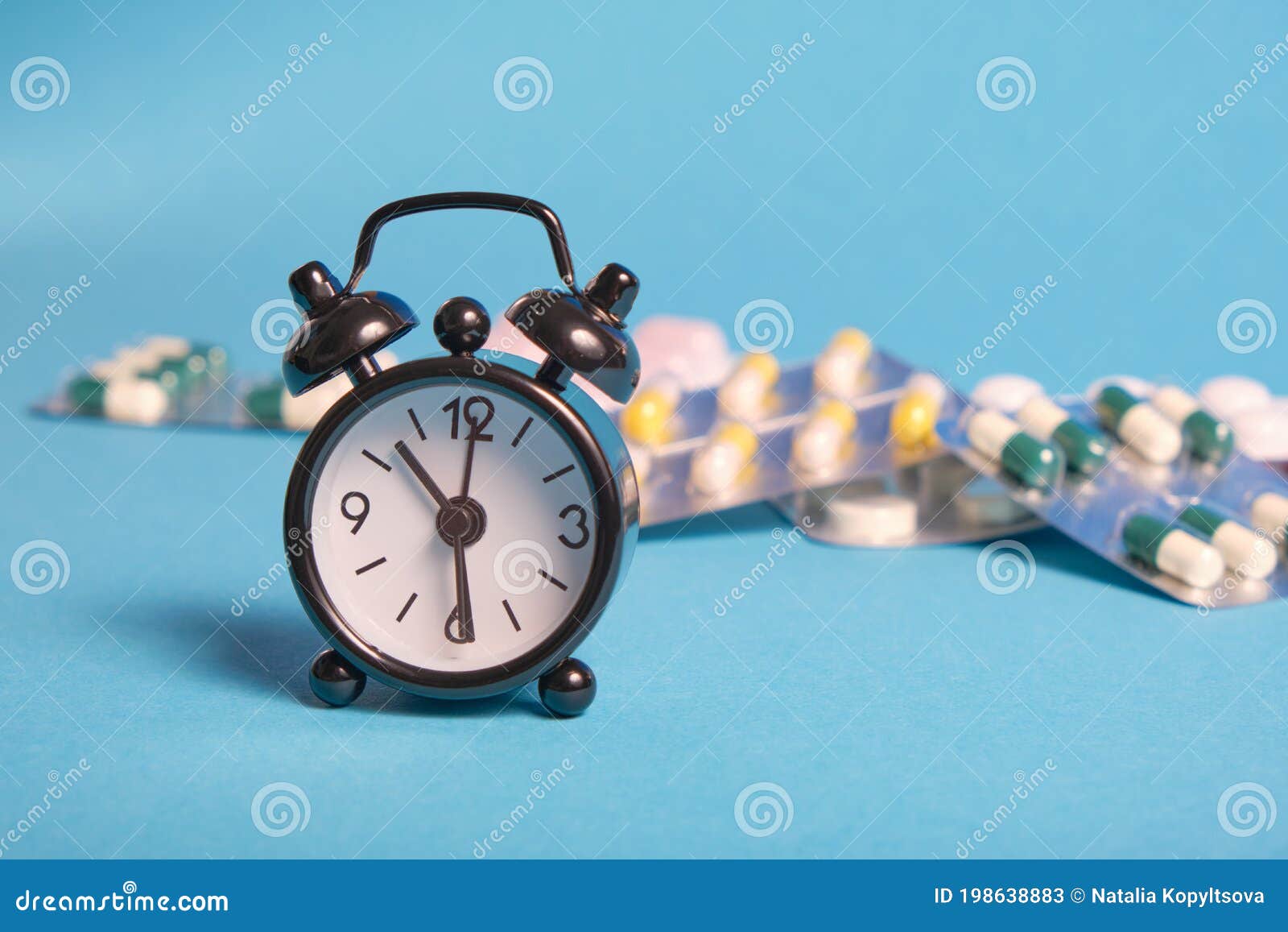 Packaging of Tablets and Pills on the Table with Clock in the Middle ...