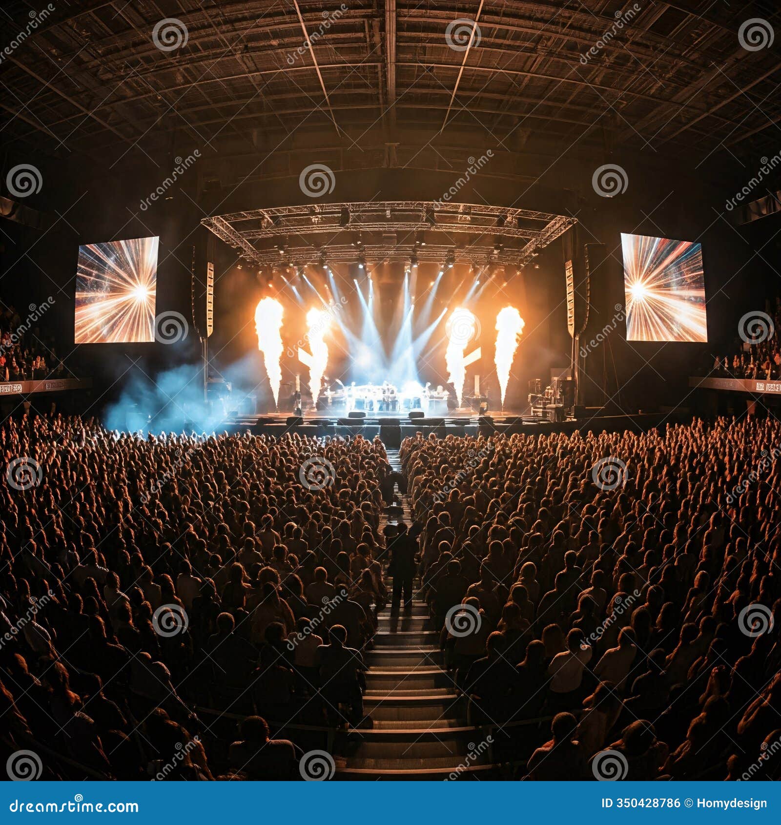 A Packed Concert Hall with a Large Crowd Facing a Brightly Lit Stage ...