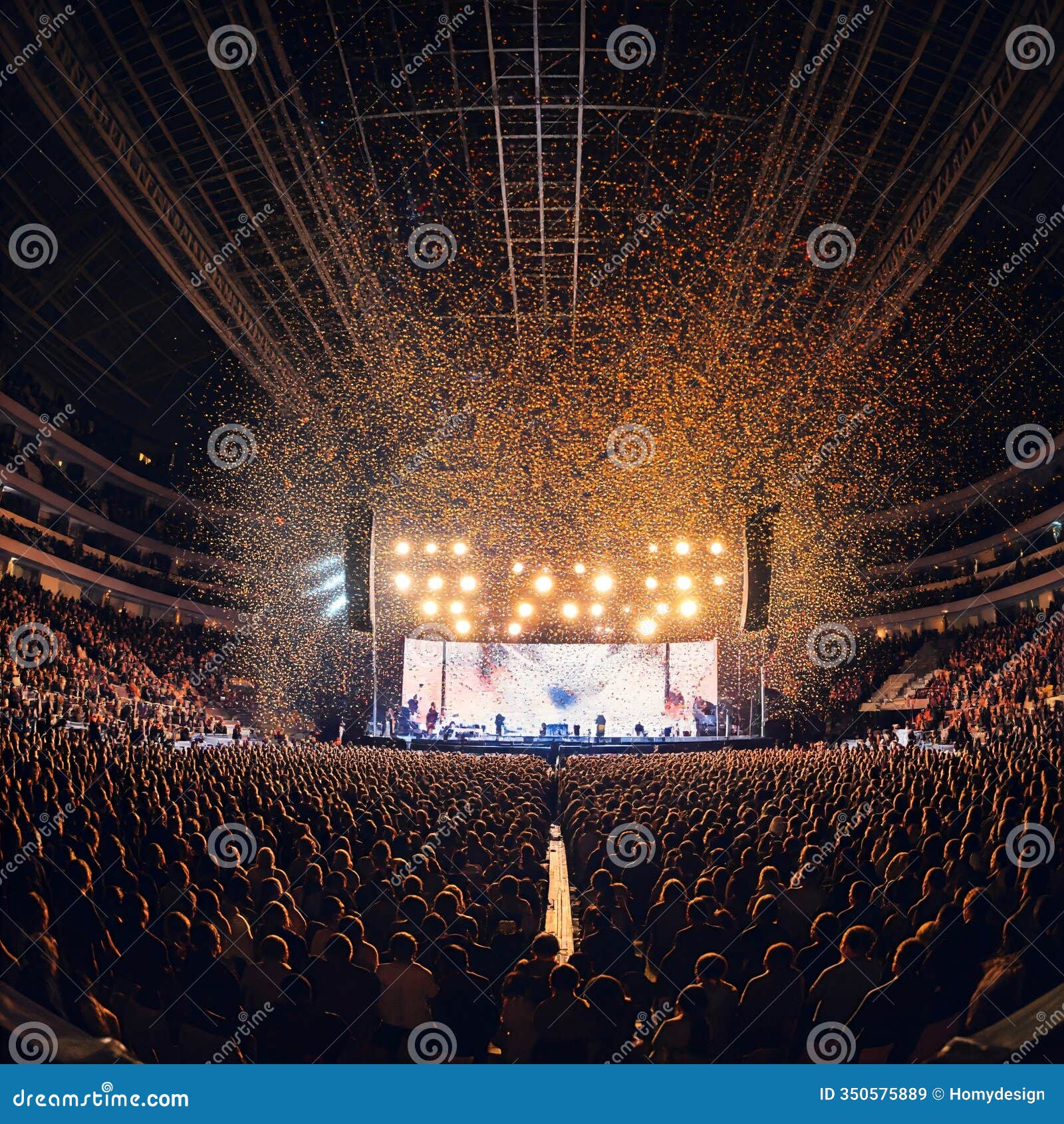 A Packed Concert Hall with a Large Crowd Facing a Brightly Lit Stage ...