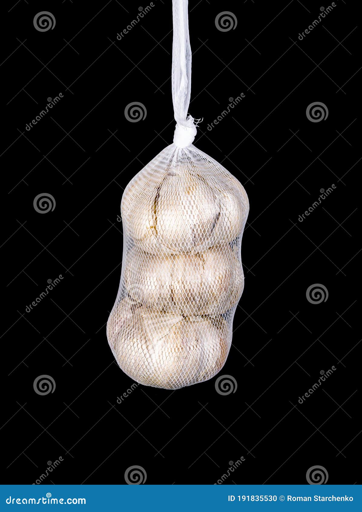 Packed Garlic in a Net Isolated on a Black Background Stock Photo ...