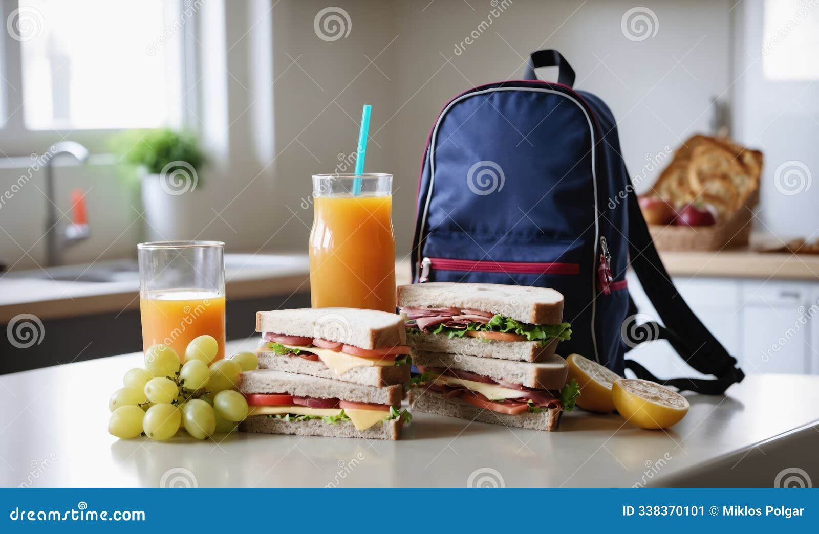 A Packed Lunch with Sandwiches, Fruit, and Juice Sits on a Kitchen ...