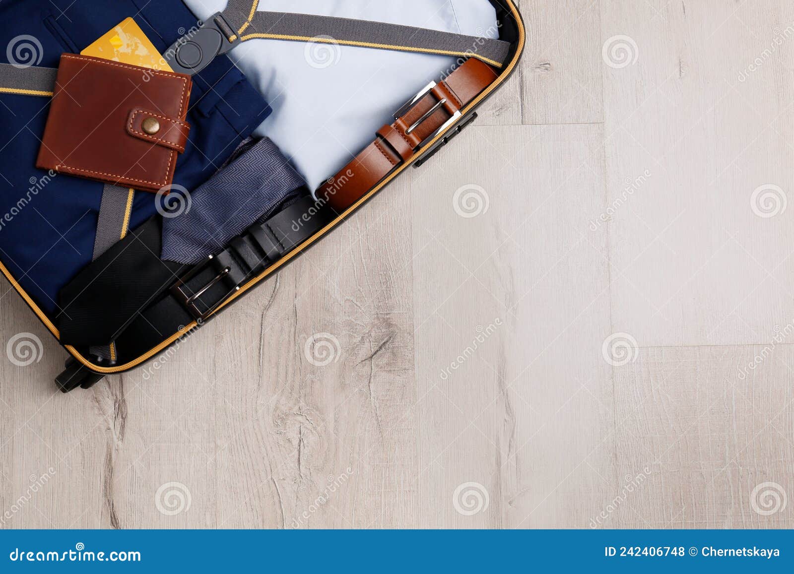 Packed Suitcase with Business Trip Stuff on Wooden Surface, Top View ...