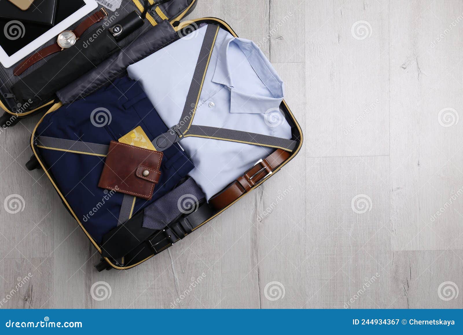 Packed Suitcase with Business Trip Stuff on Wooden Surface, Top View ...