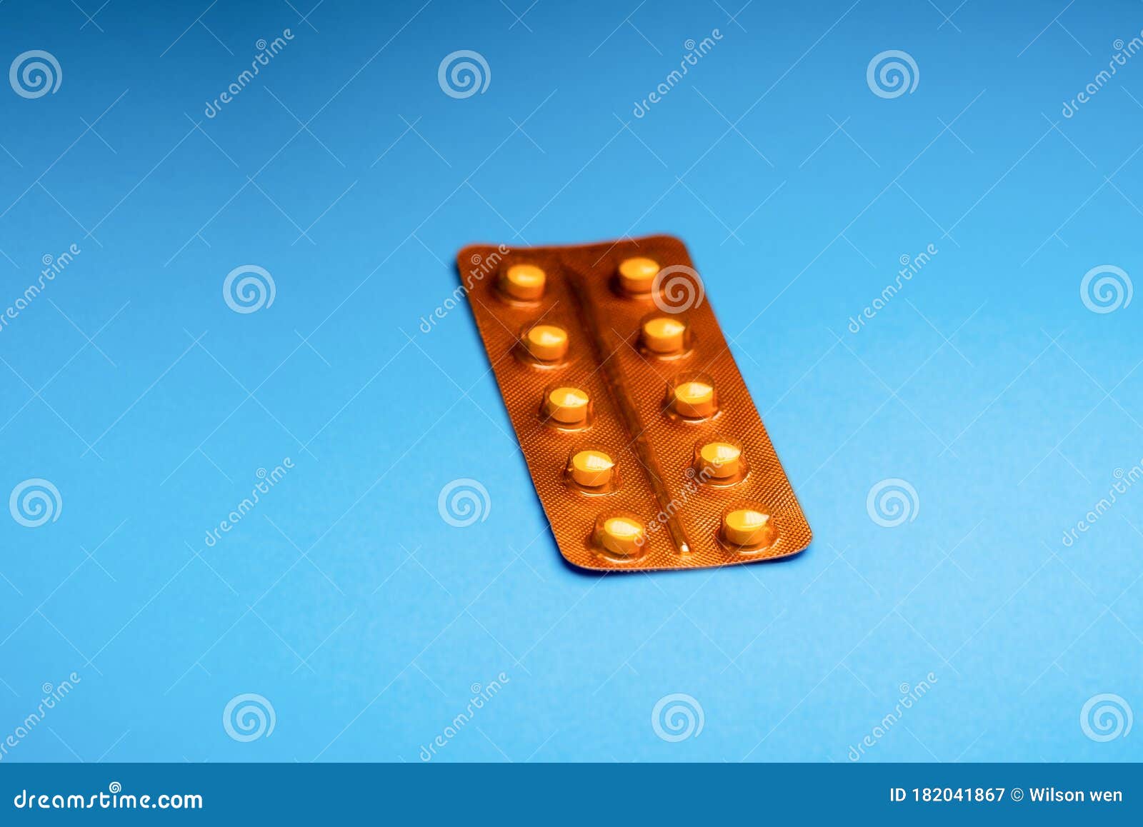 A Packet of Orange Pill Sealed on a Blue Background Stock Image - Image ...