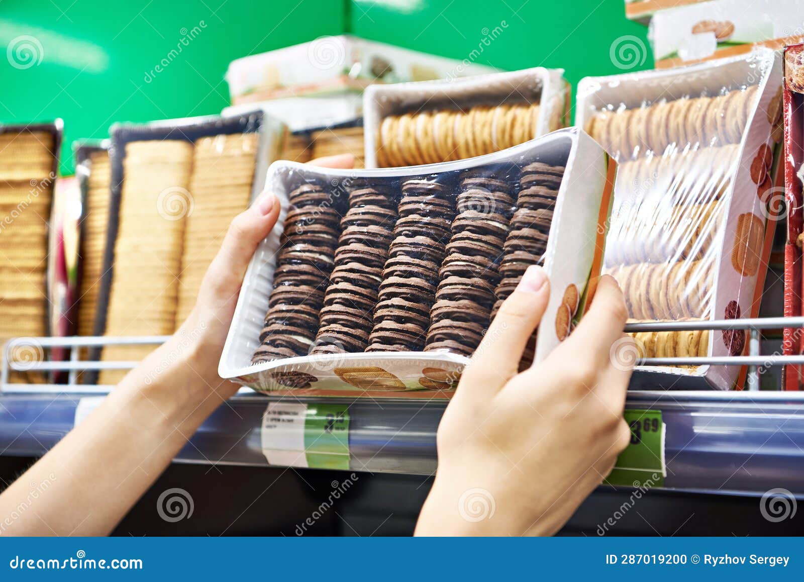 Packets of Chocolate Cookies in Hands of Buyer Stock Photo - Image of ...