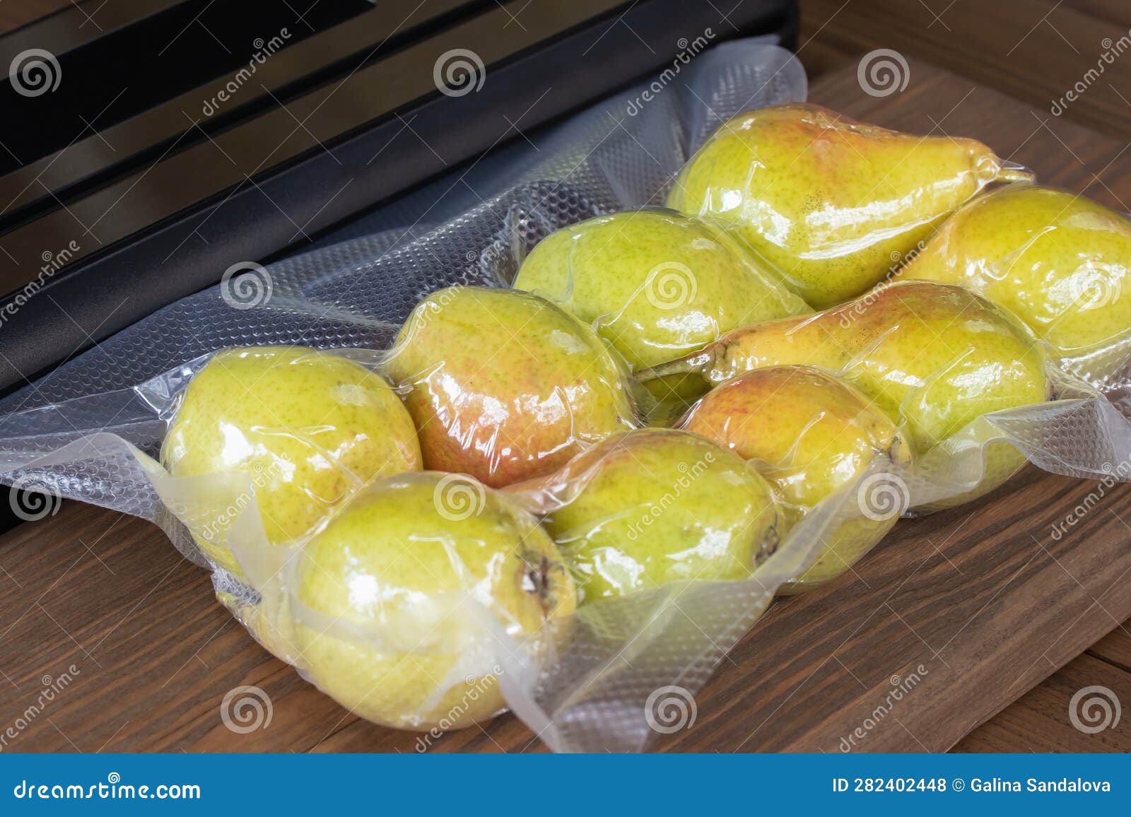 Packing Fresh Pears with a Vacuum Packer for Long-term Storage Stock ...