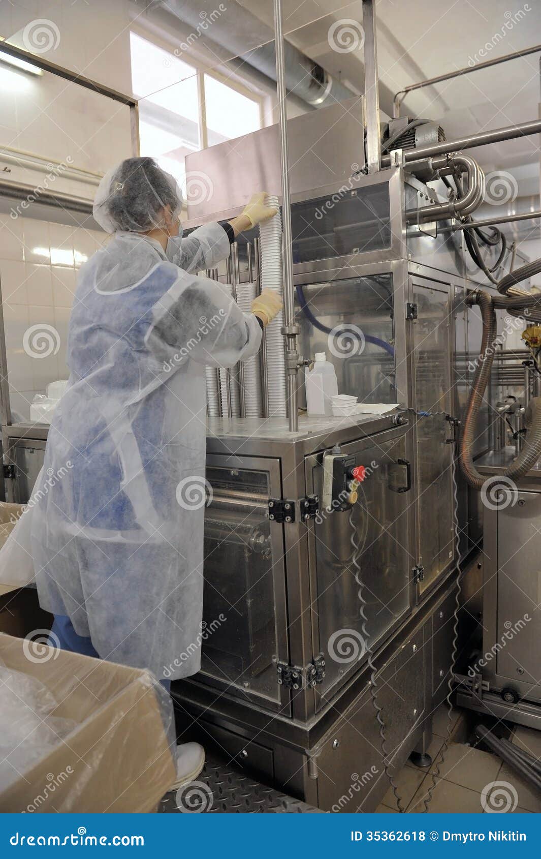At The Plant. Workers Holding The Metal Sheet Working With The CNC ...