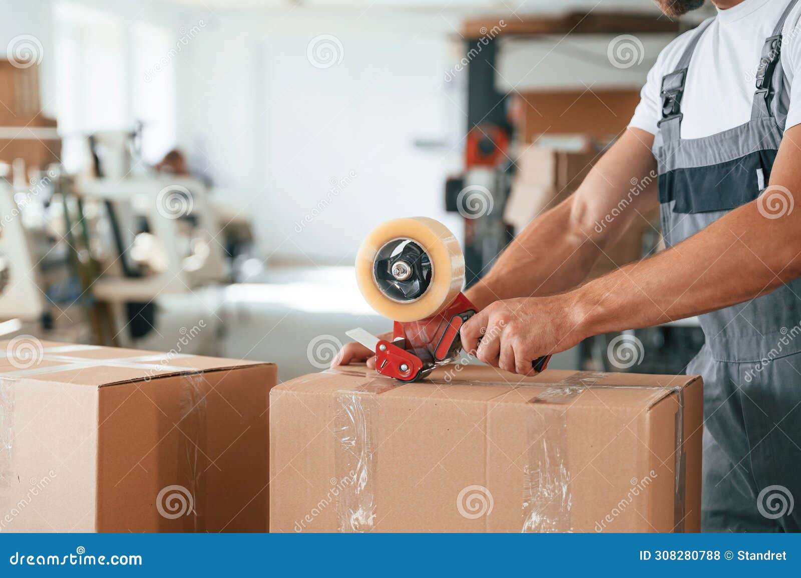 Packing the Product. Handsome Man is Working at the Factory of Creating ...