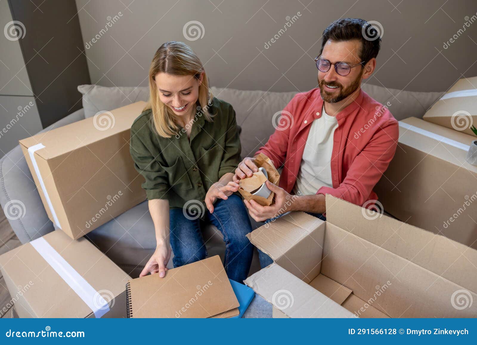 Two People Looking Busy while Packing the Boxes for Relocation Stock ...