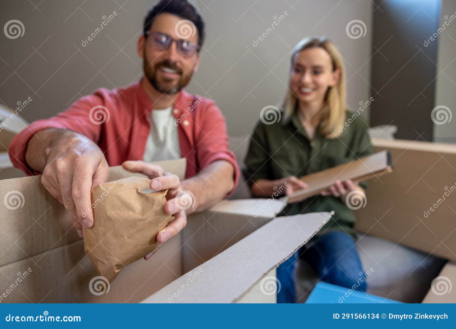 Two People Looking Busy while Packing the Boxes for Relocation Stock ...