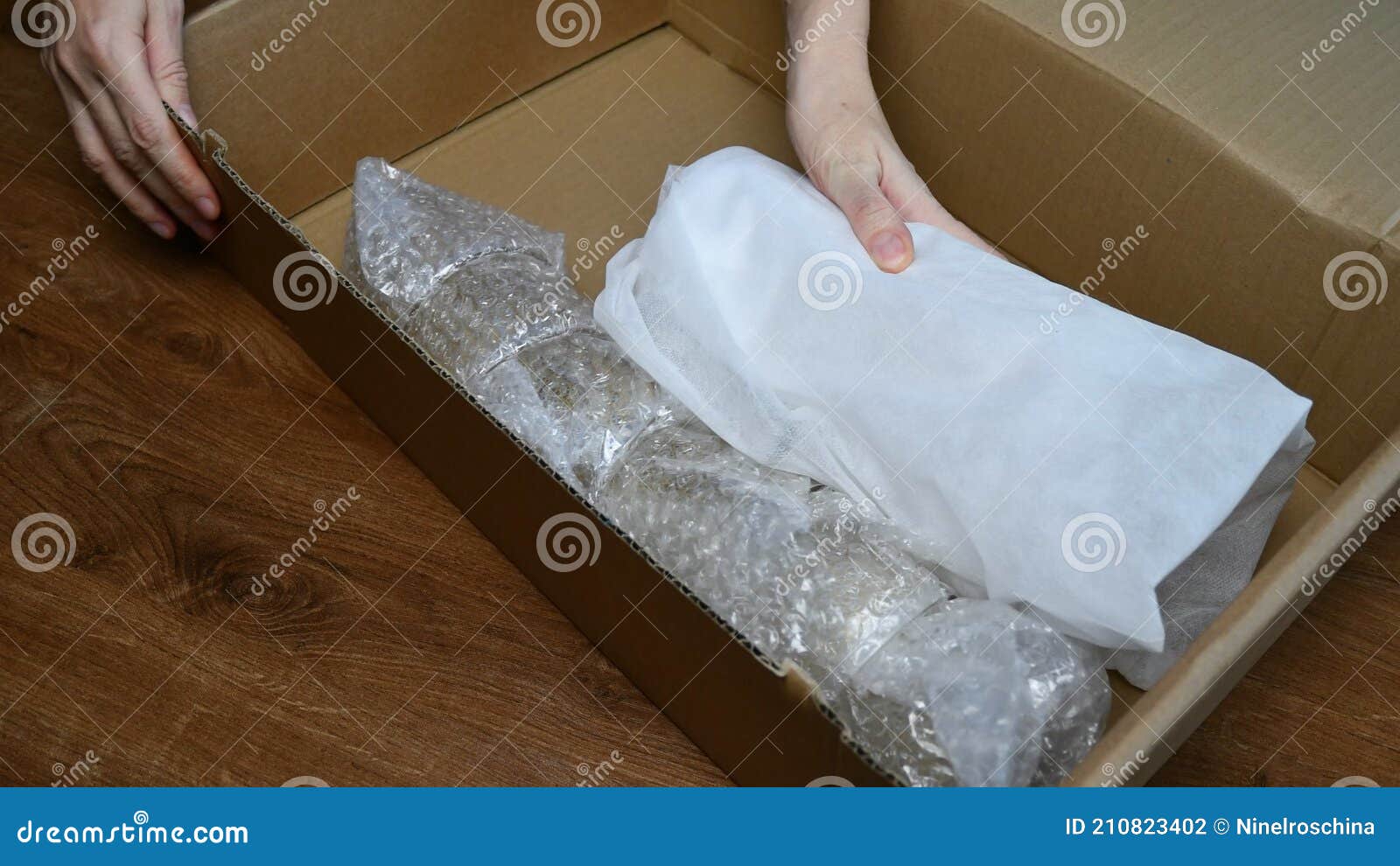 Packing Up Fragile Tableware into Plastic Bubble Wrapping Inside ...