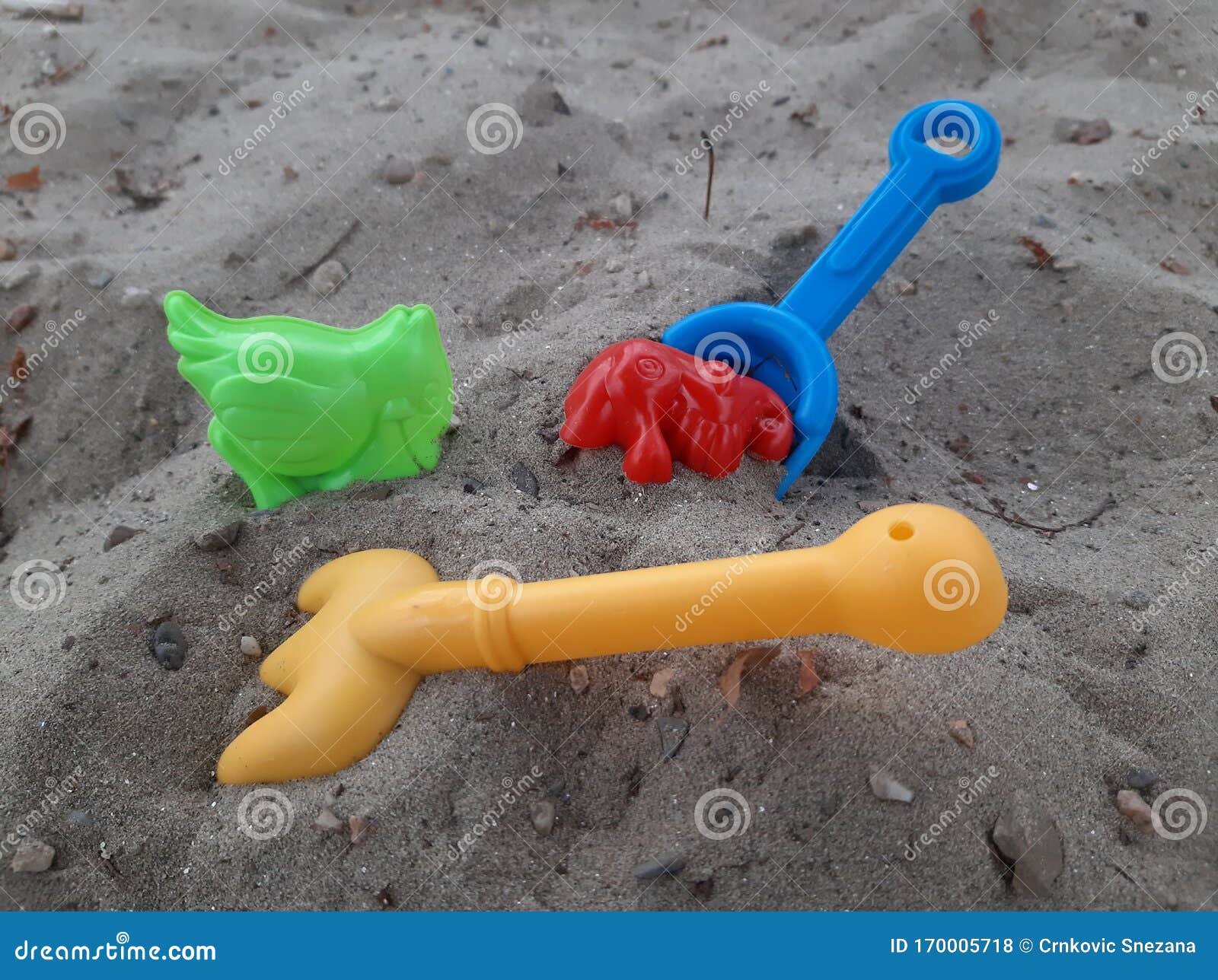 A Paddle and a Rake in the Sand Stock Photo - Image of element, blue ...
