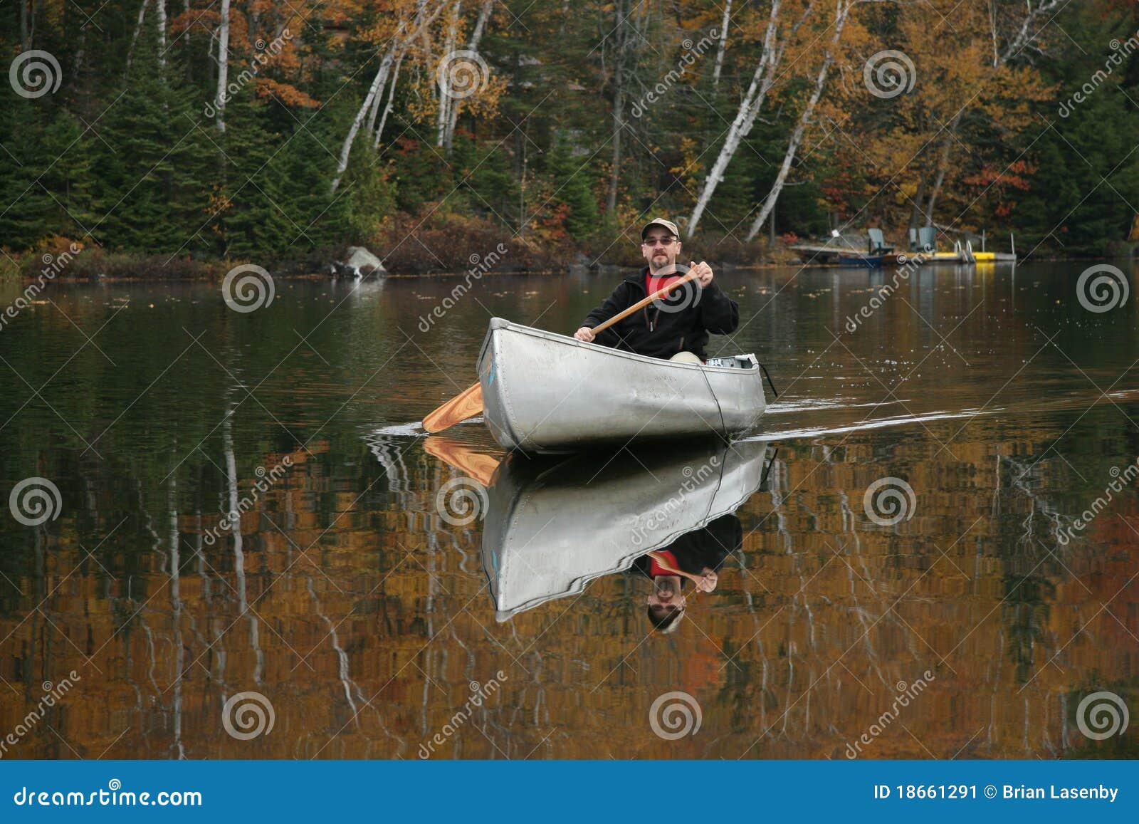 Paddling a Canoe on an Autumn Lake Stock Image - Image of canoeist ...