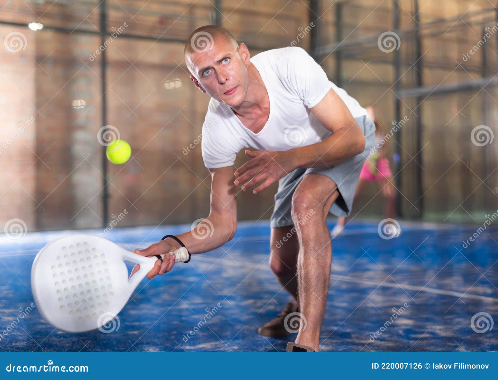 Padel Player Playing Padel in a Padel Court Indoor Behind Net Stock ...