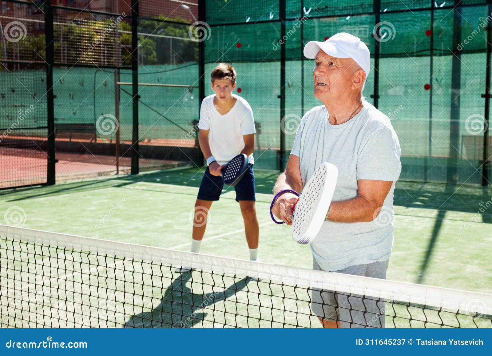 Padel Players of Different Generations Playing Padel Court Stock Image ...