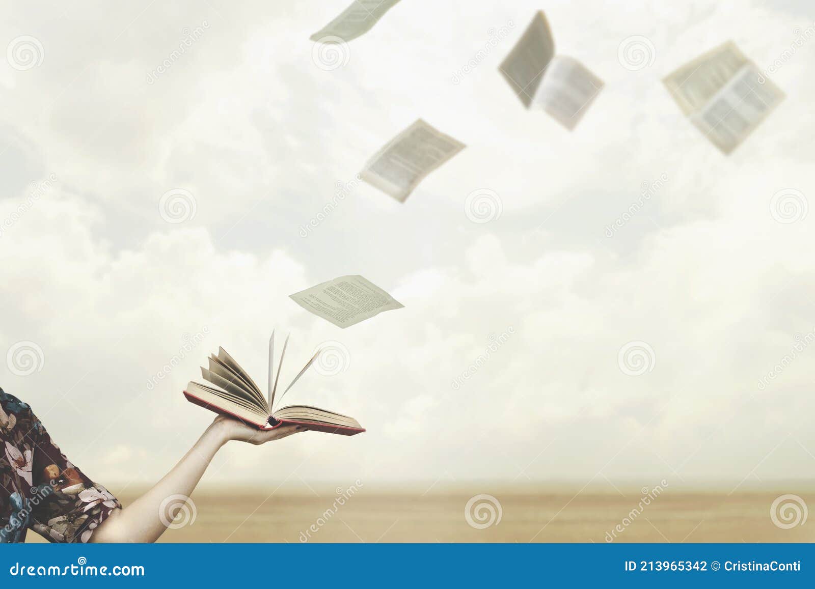 Pages Fly Free in the Sky from a Book Held Open by a Woman Stock Photo ...