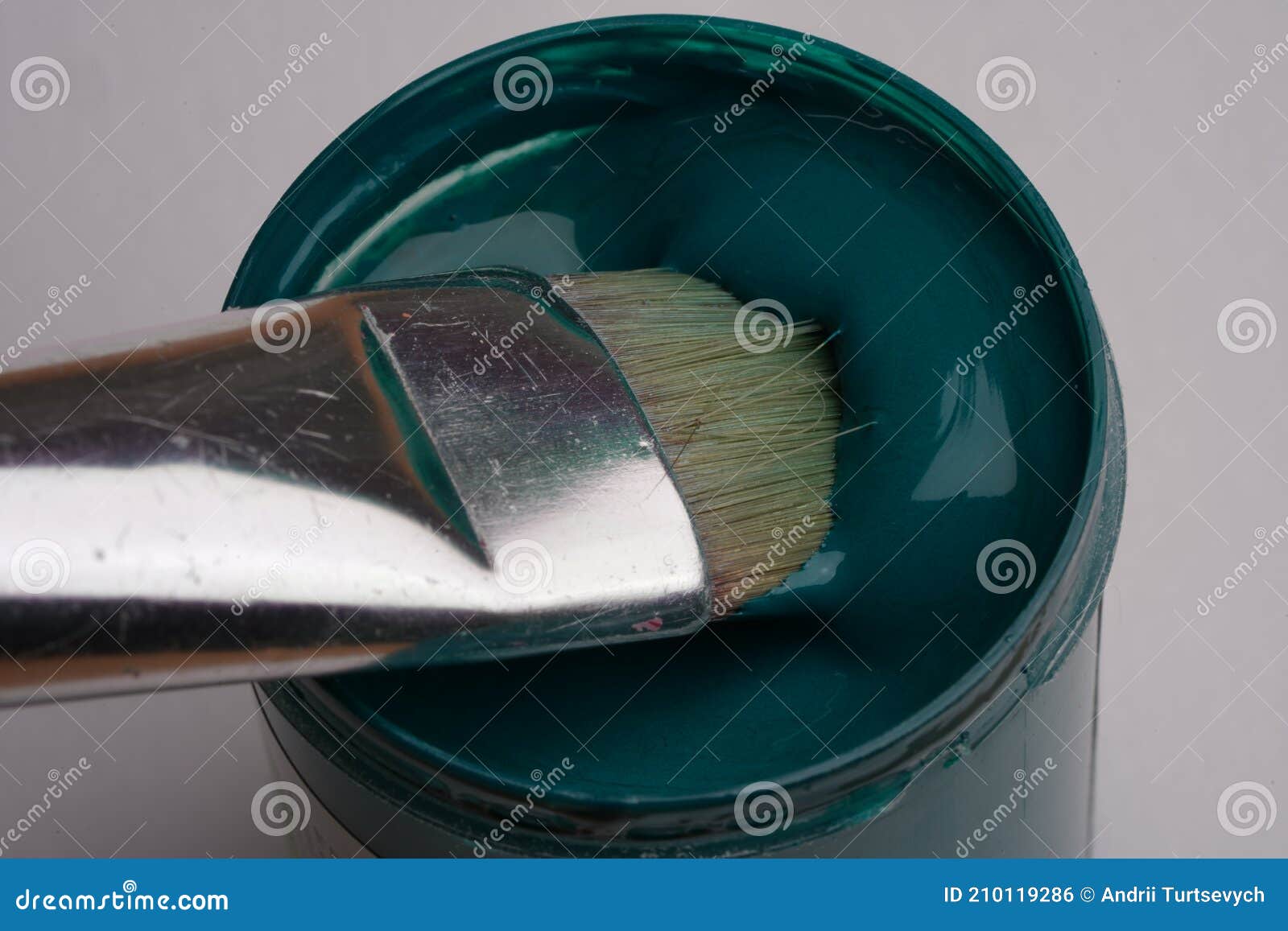 Paint Brush in Tidewater Green Paint Half Submerged in a Paint Can ...