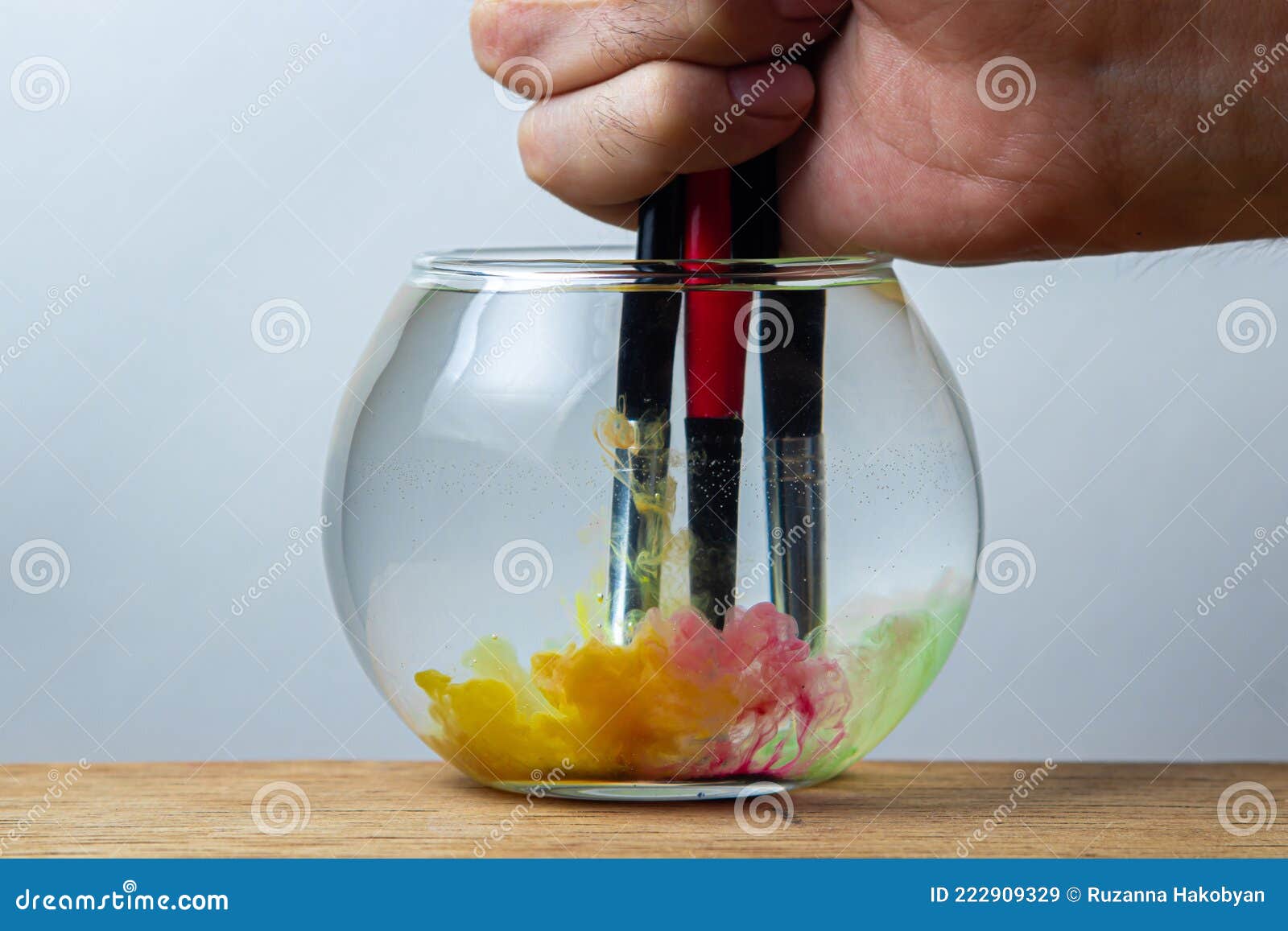 Paint Brushes Dipped in a Jar of Water on a White Background. Stock ...
