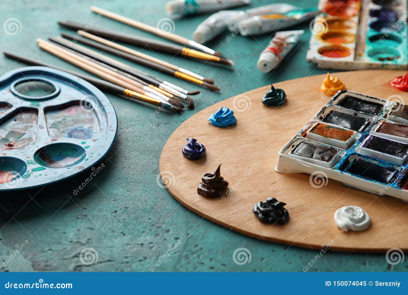 Paint Palettes And Brushes Being Used On An Artist Workshop Table ...