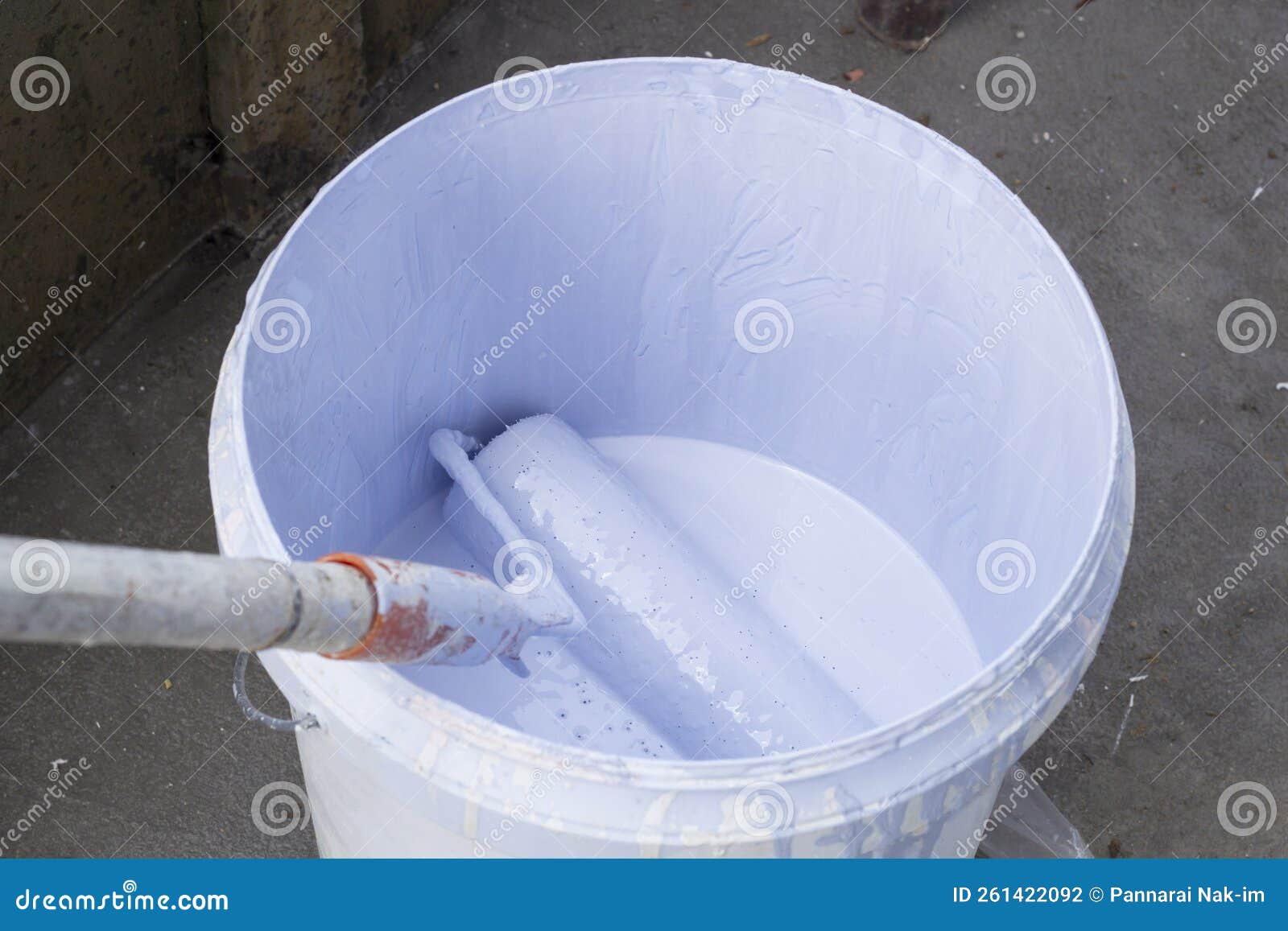 Paint Roller in White Bucket in Construction Site. Stock Photo - Image ...
