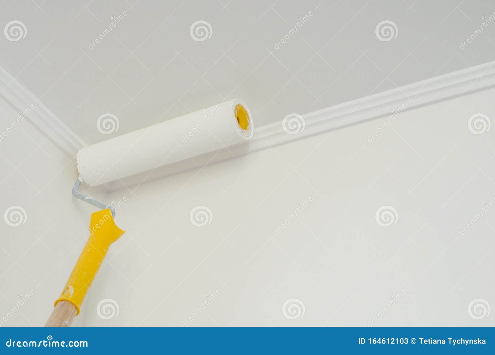 Paint Roller with Yellow Handle. Ceiling and Wall Painting Process ...