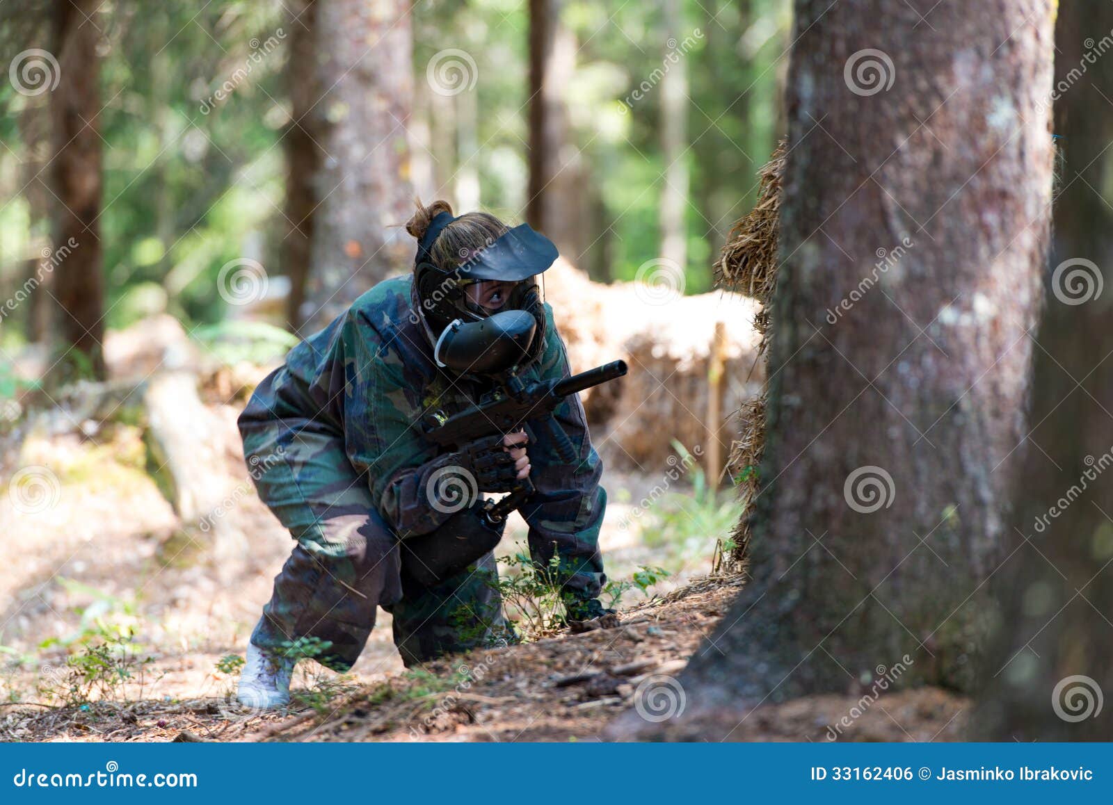 Paintball Player Hide Behind Tree Stock Photo - Image of clothing ...