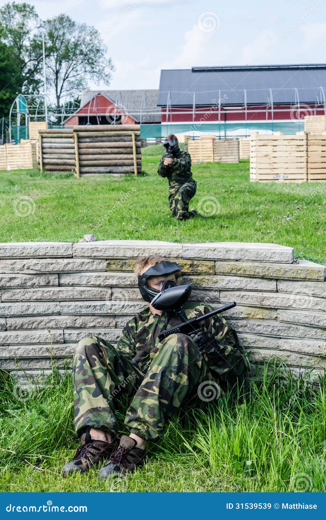 Paintballer Hiding Behind Wall Stock Image - Image of forest, player ...