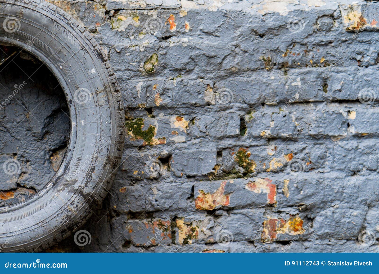 Painted in Grey Tyre Lies on the Gray Brick Wall Stock Image - Image of ...