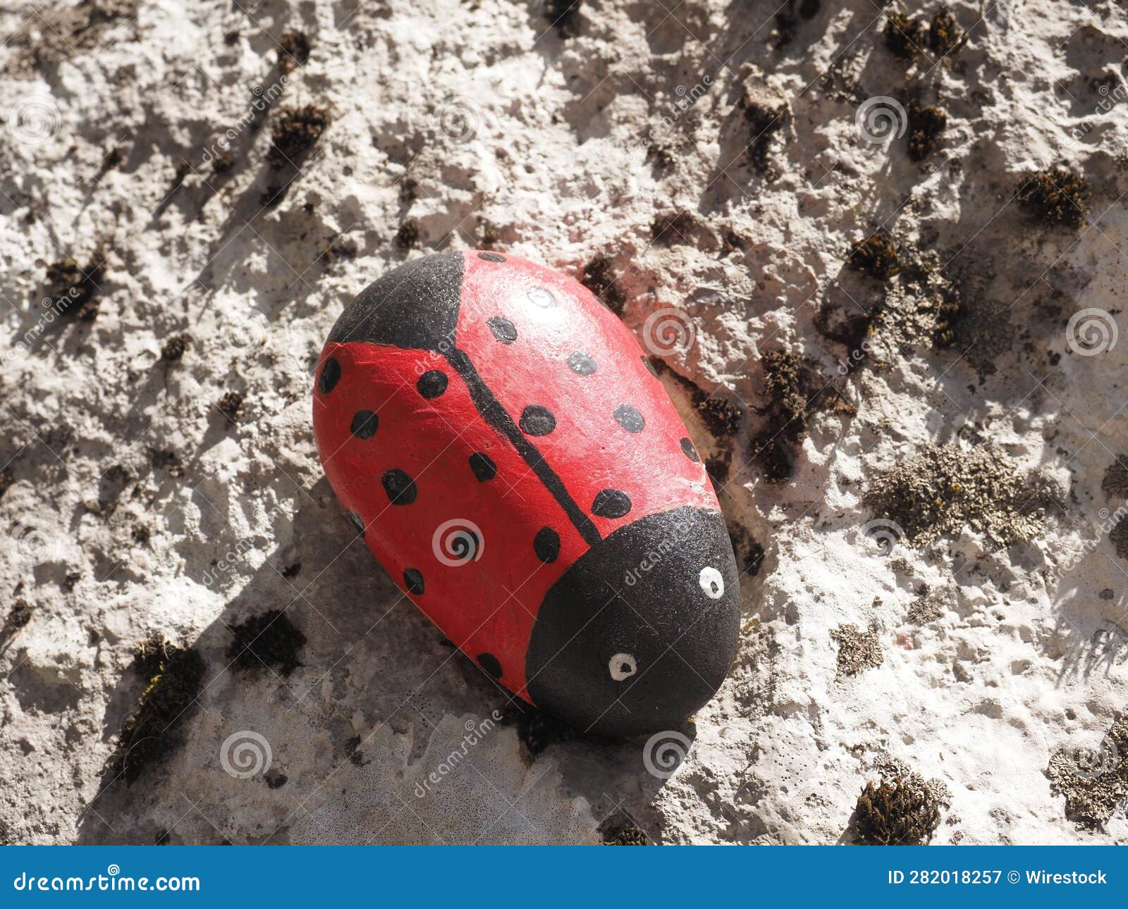 A Painted Ladybug is on Top of Some Sand Stock Image - Image of ...