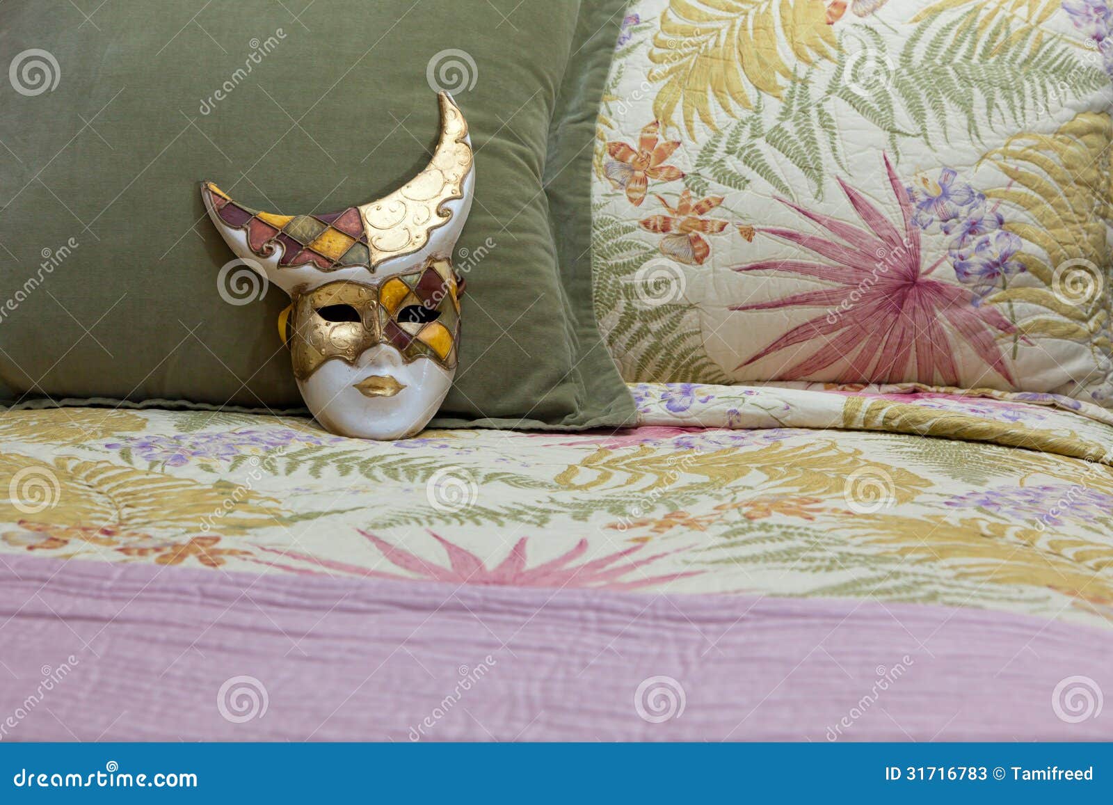 Painted Mask on a Bed stock image. Image of object, green - 31716783