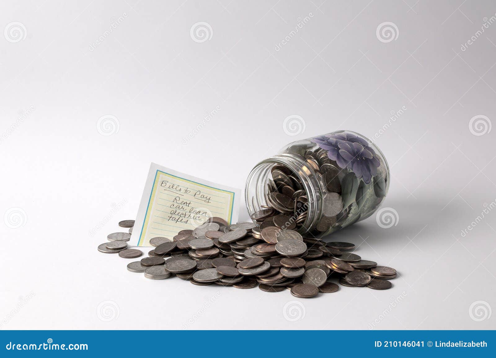 A Painted Mason Jar Tipped on Its Side Spilling Out Coins with a List ...