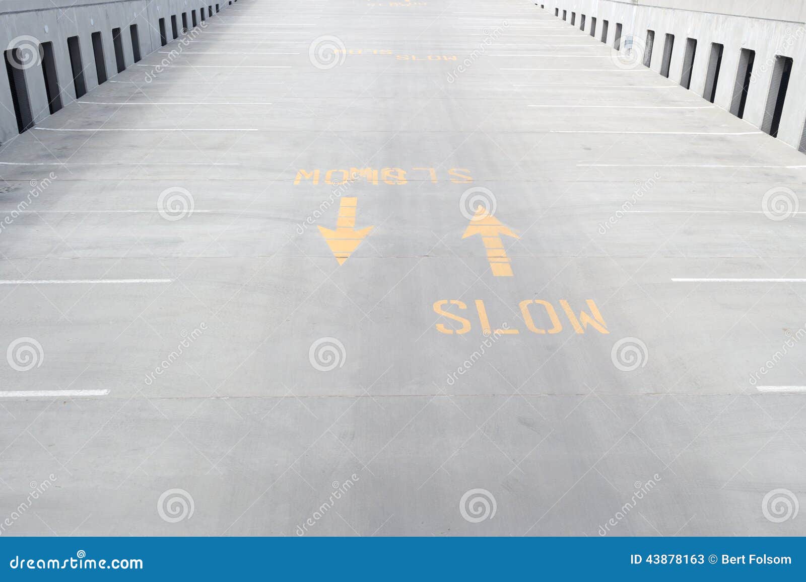 Painted Slow Sign with Arrows on Concrete Ramp Stock Image - Image of ...