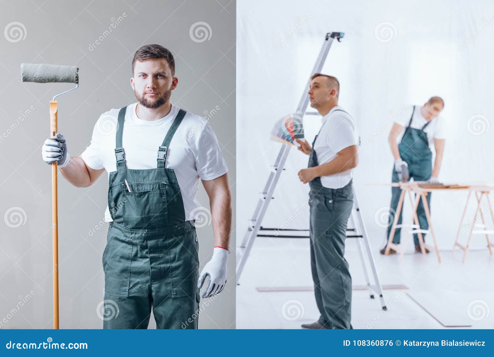 Painter holding roller stock photo. Image of gloves - 108360876