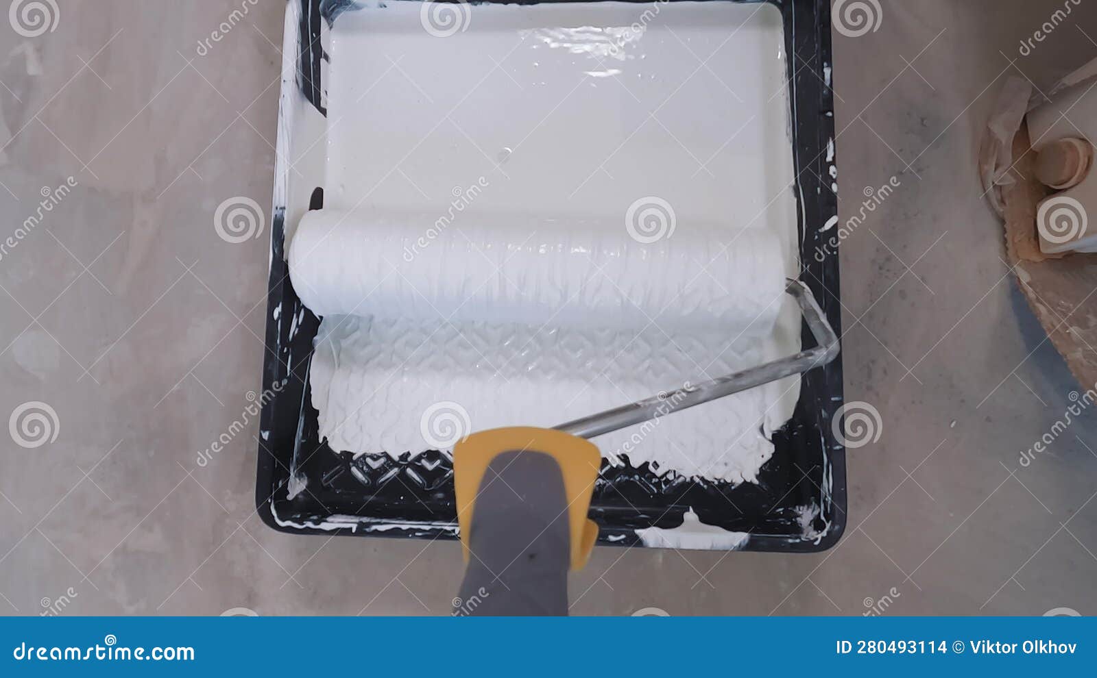 The Painter Lowers the Roller for Painting the Walls into a Container ...