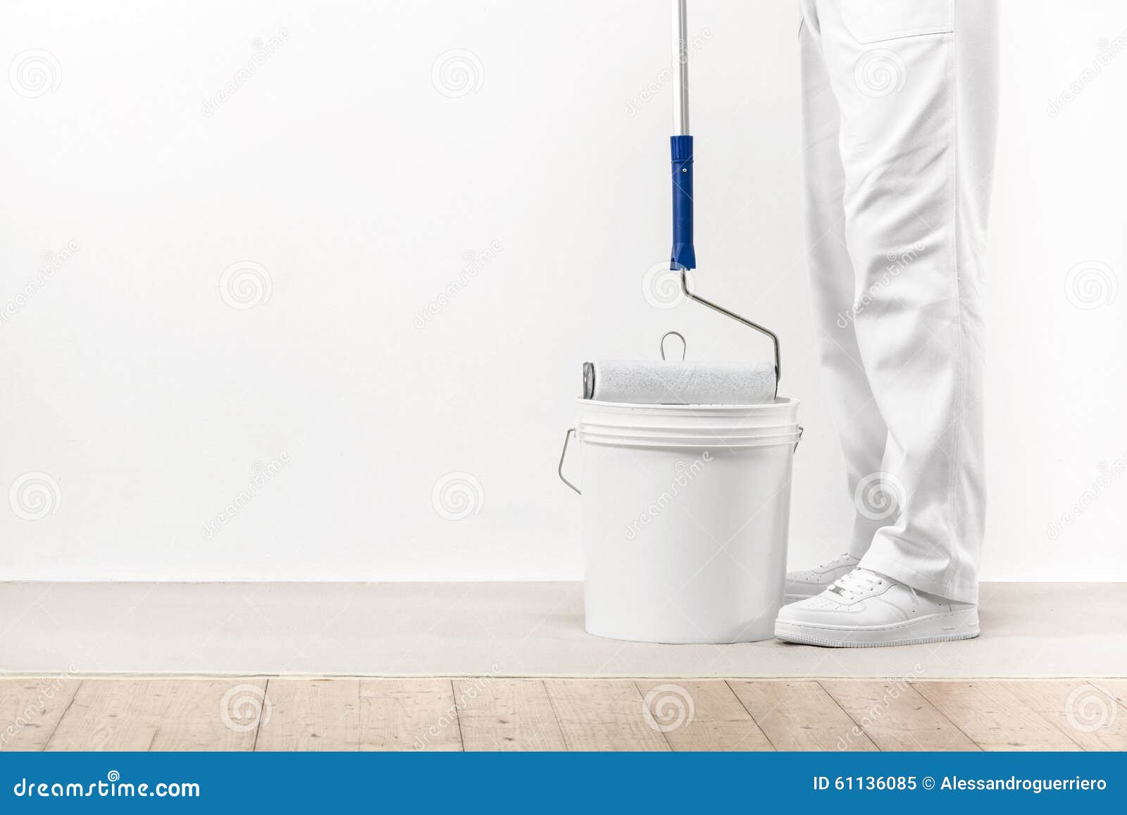 Painter Man Takes the Color with Paint Roller from the Bucket. Stock ...