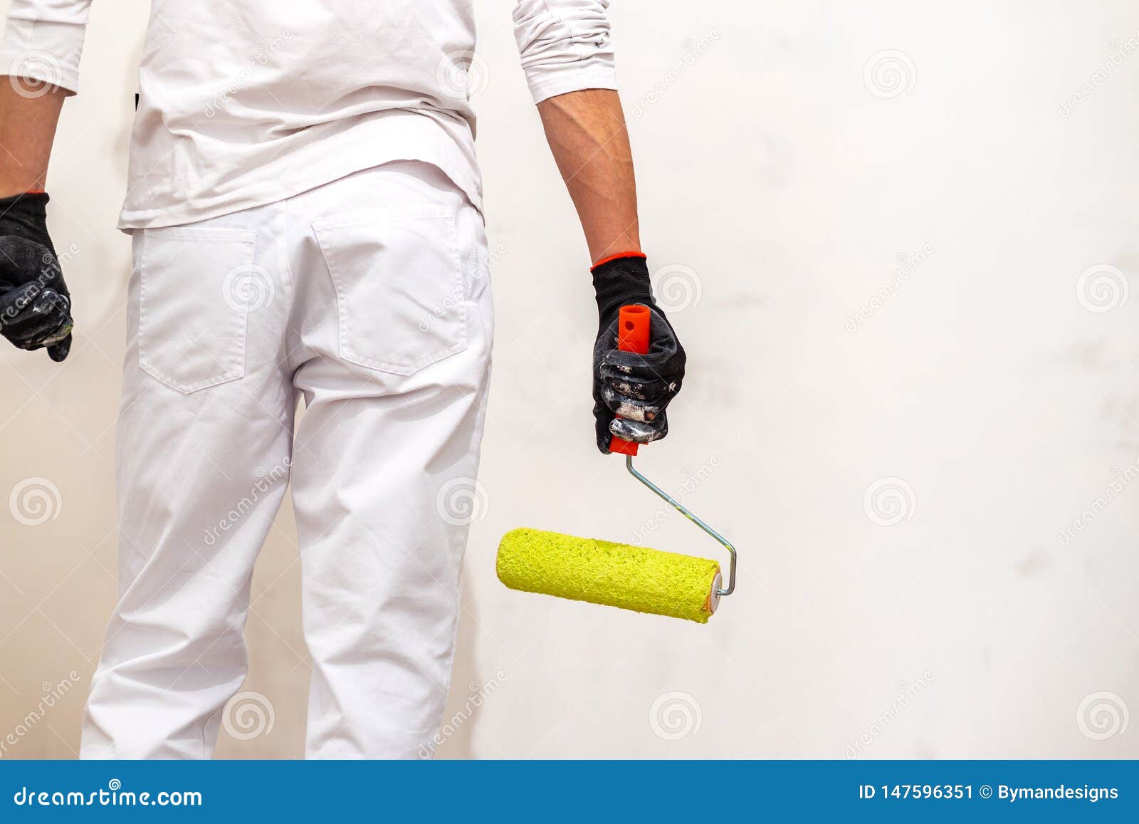 Painter Man at Work with a Paint Roller Looks at the Wall Stock Image ...