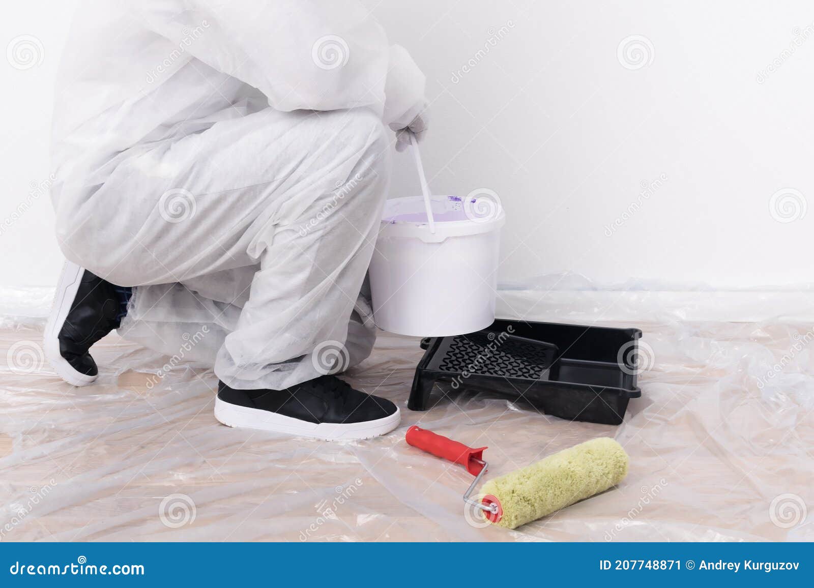 A Painter in a Protective Suit Pours Paint into a Tray Stock Image ...