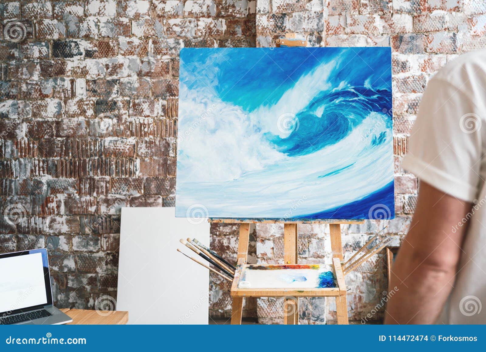 Painter Stands in Front of the Easel with a Canvas and Considers His ...