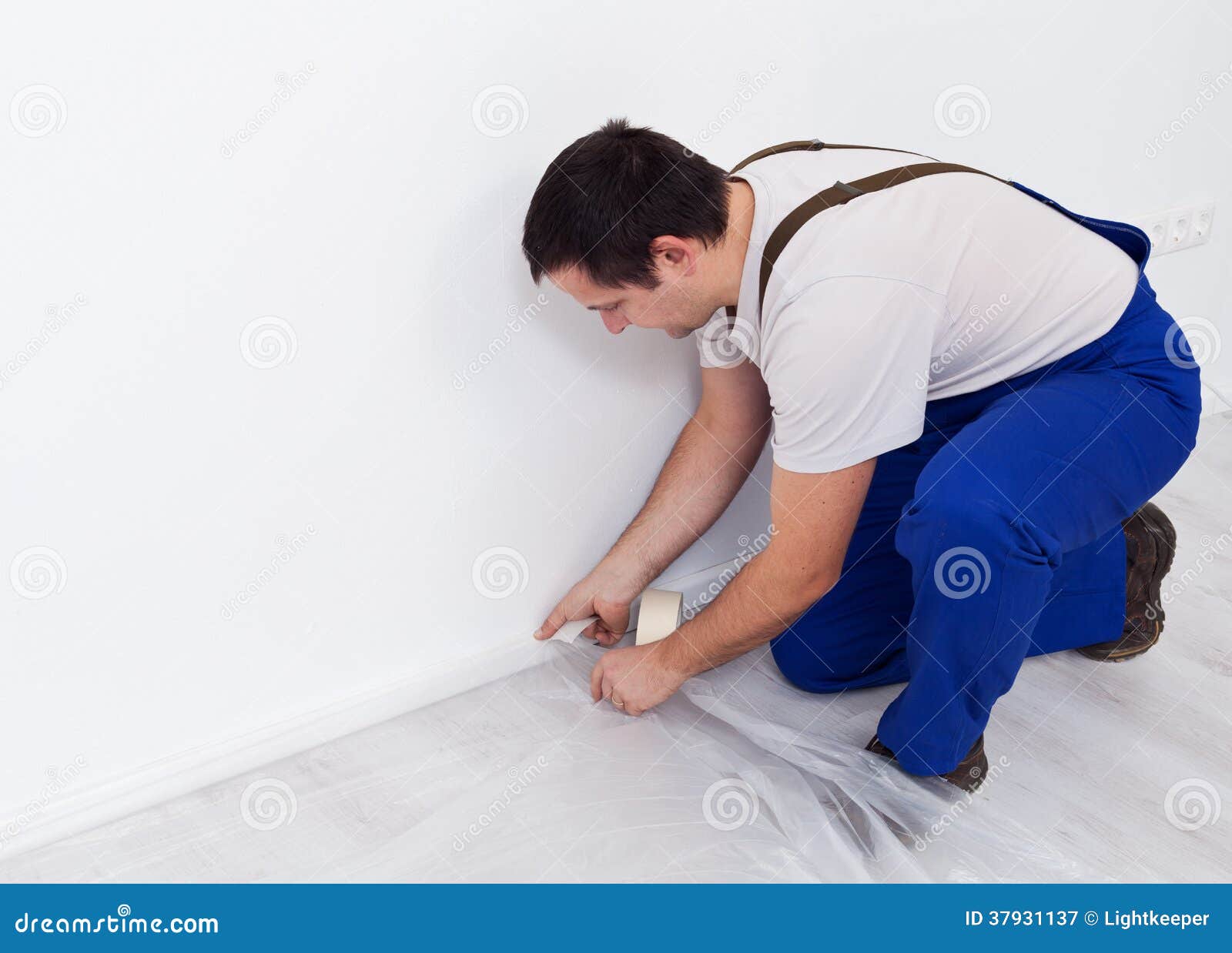 Painter Worker Preparing the Room - Laying Protection Film Stock Image ...
