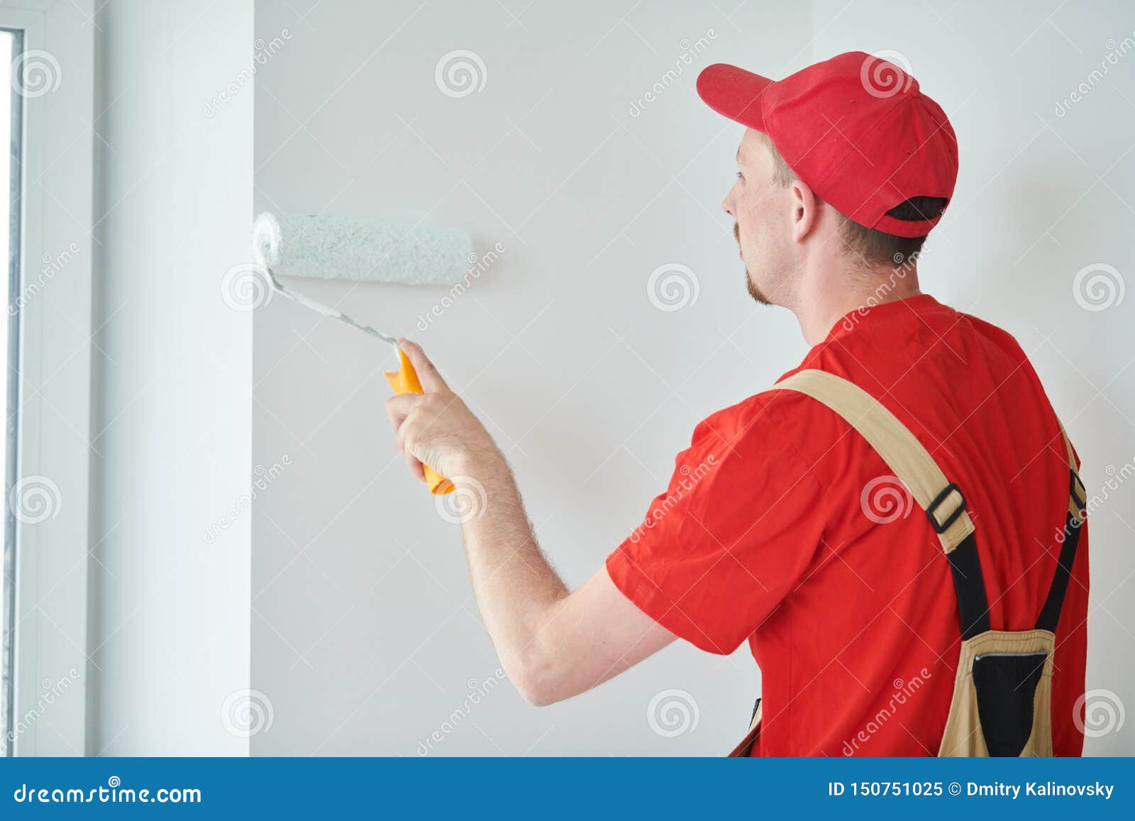Painter Worker with Roller Painting Wall Surface into White Stock Image ...