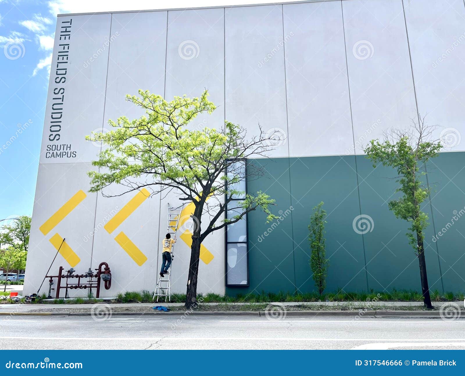 A Painter Works on Signage at the South Campus of Fields Studios in May ...