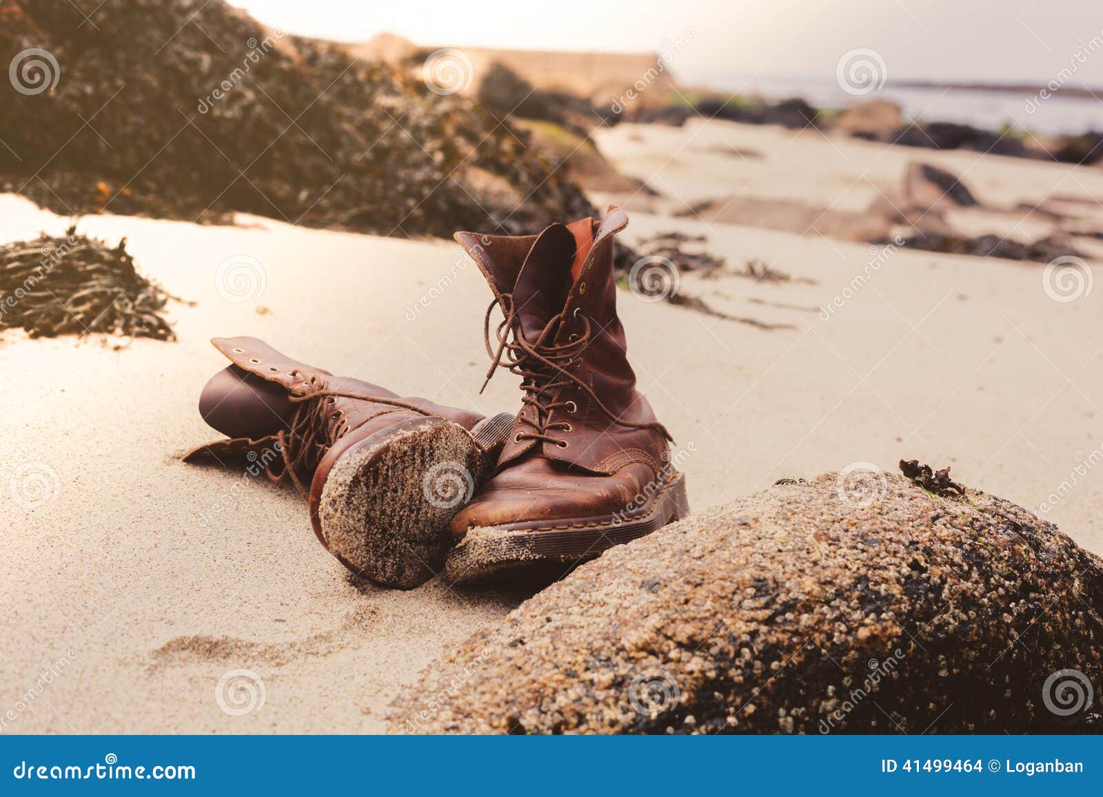 Pair of boots on the beach stock photo. Image of leather - 41499464